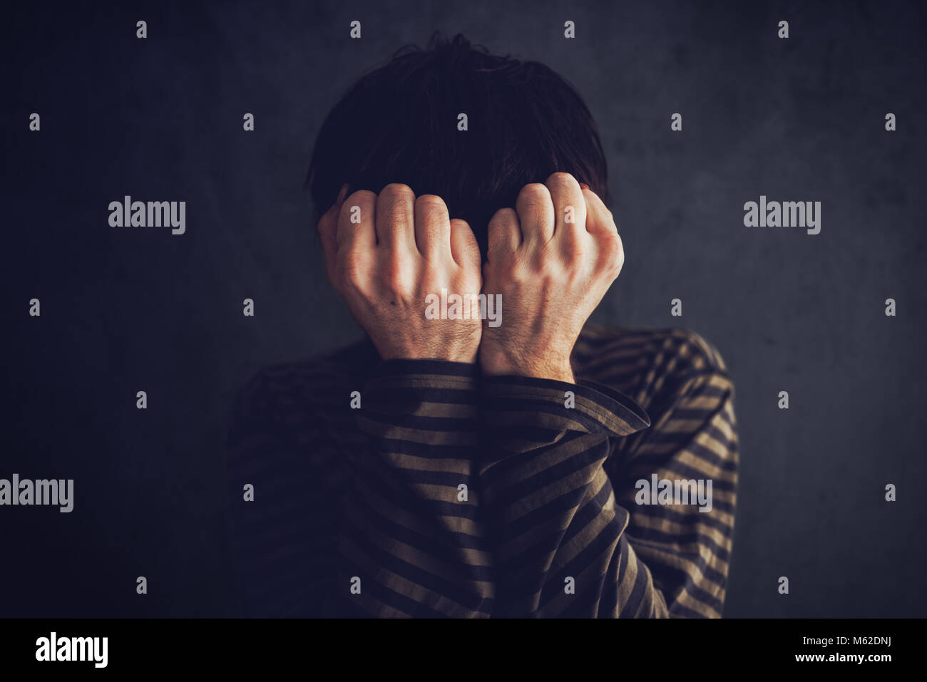 Distraught state of mind, depressive and sad man in dark room Stock ...