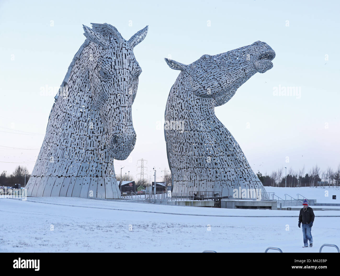 A man walks near the Kelpies in Falkirk, as heavy snow has caused more ...