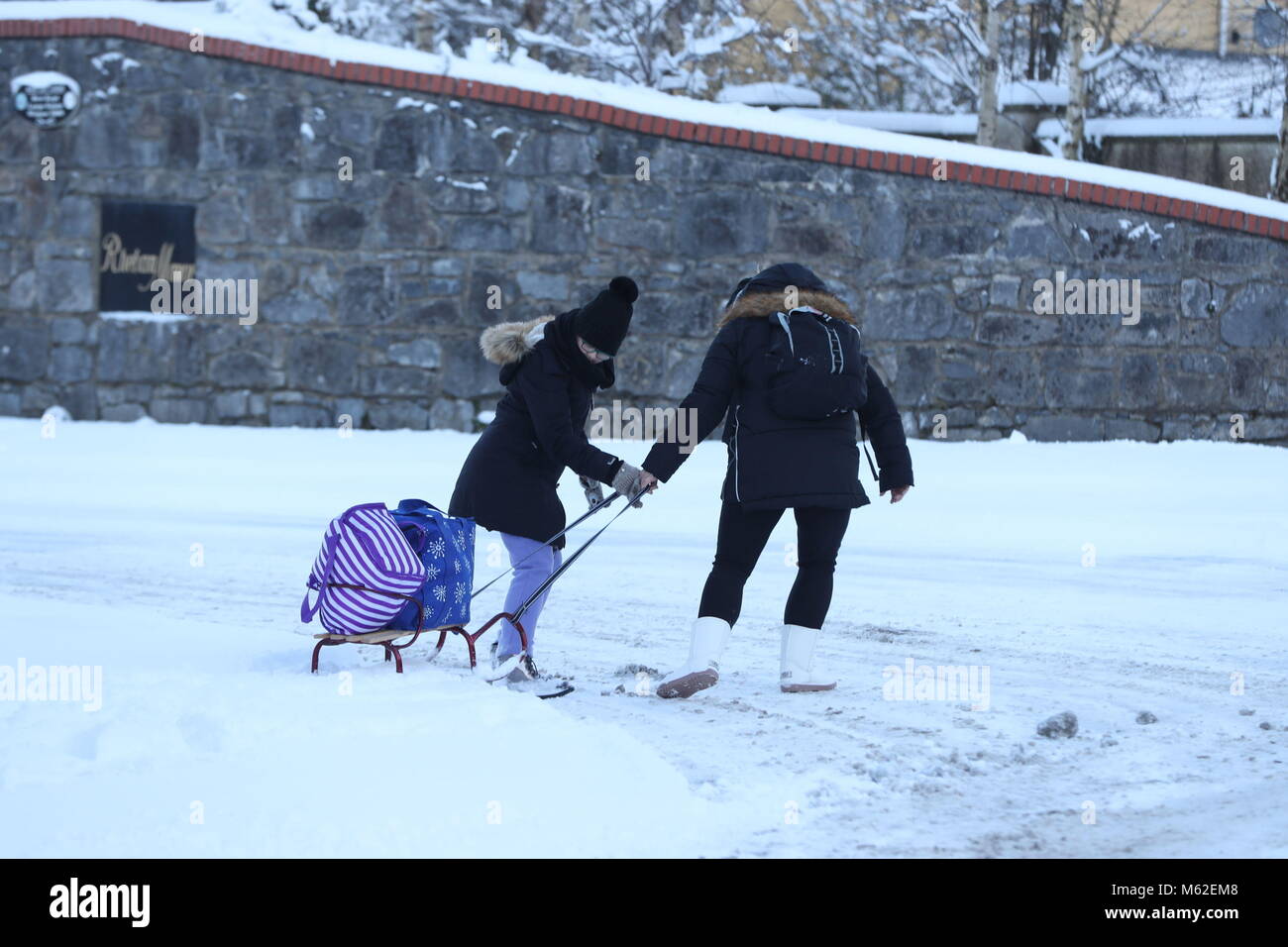 People drag their shopping on a sledge through the snow in Athy, Co ...