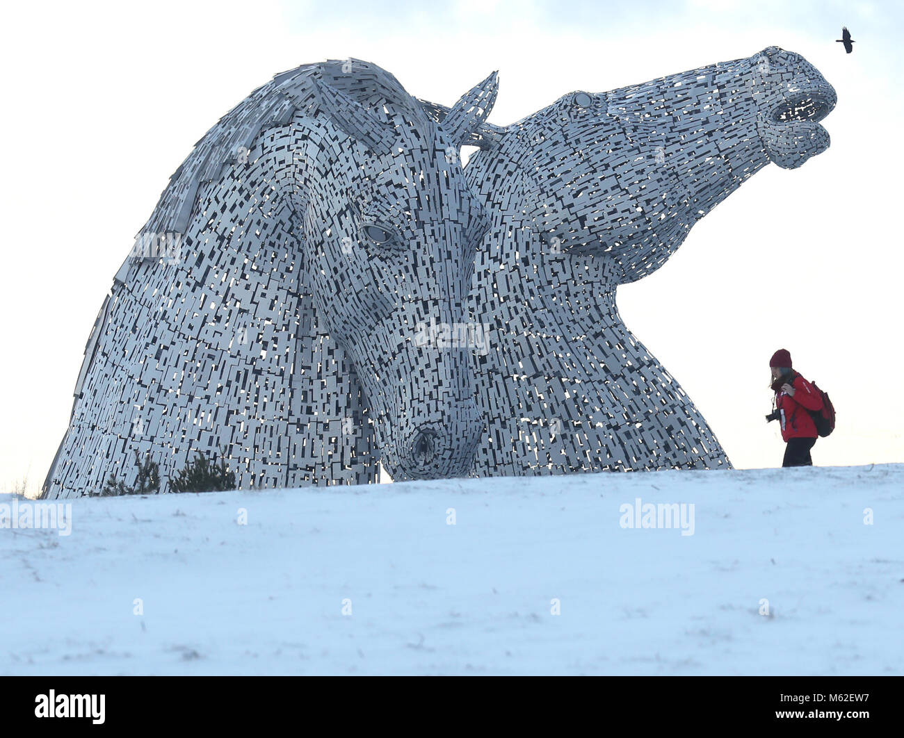 A person walks past the Kelpies in Falkirk, as heavy snow has caused ...