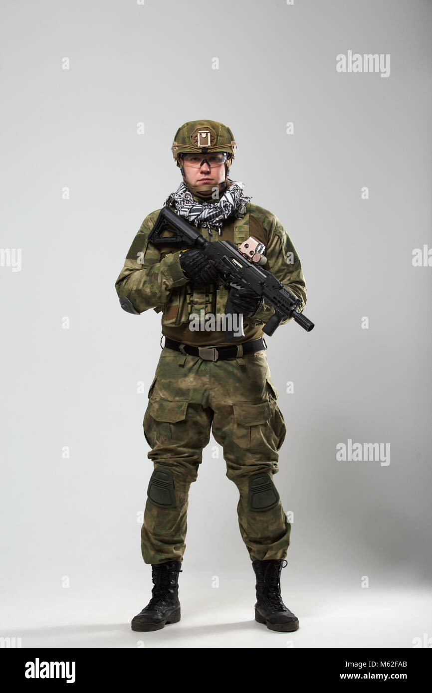 Full-length photo of soldier with gun in his hand Stock Photo - Alamy