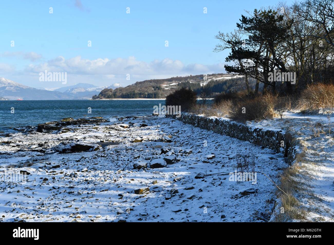 Snow on Inverkip beach looking over the Clyde towards Dunoon Stock ...