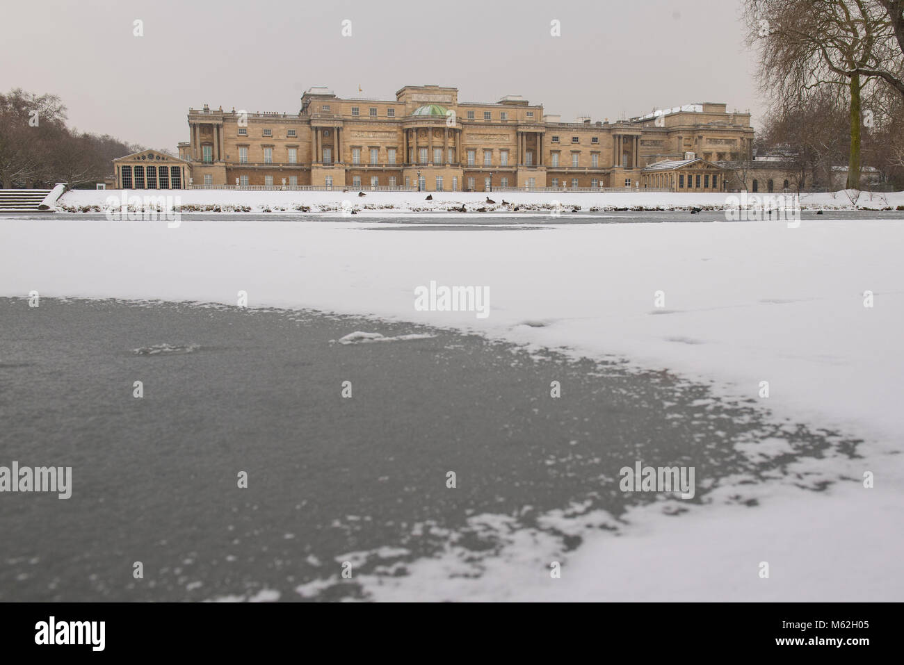 Snow and ice covers a lake in the gardens at Buckingham Palace, London ...