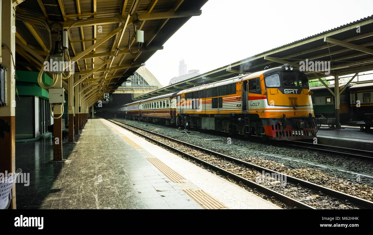Old diesel train running for reconnect at a platform of railway station ...