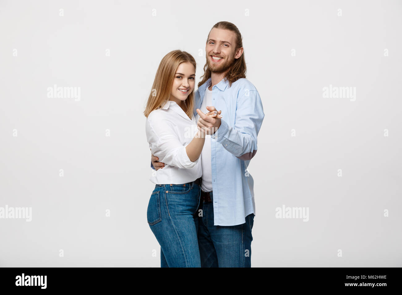 Young elegant couple in casual cloth dancing over Isolated on white ...