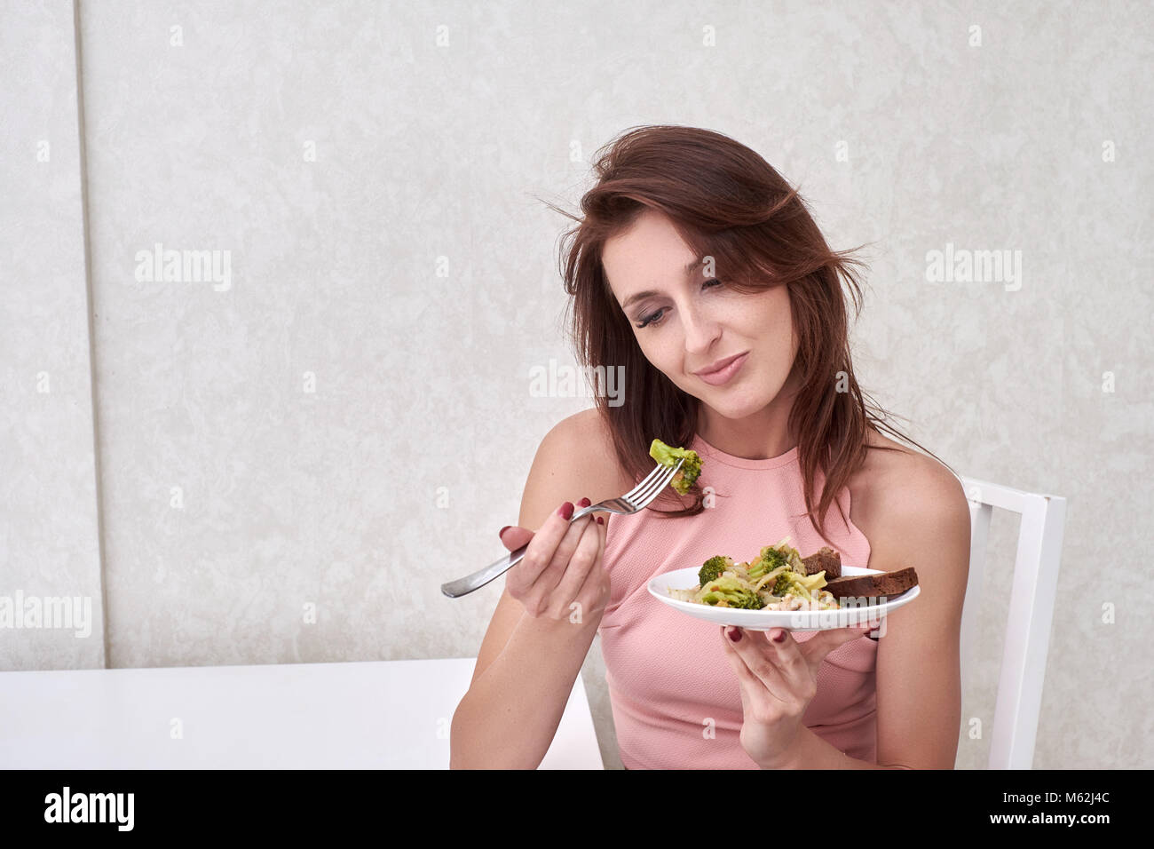 Sad woman eating salad hi-res stock photography and images - Alamy