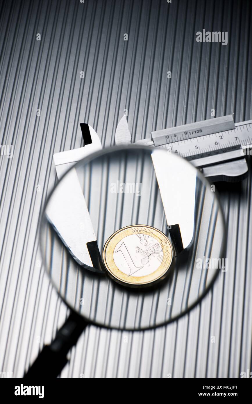 metal gauge measuring a one euro coin on a metal surface Stock Photo ...