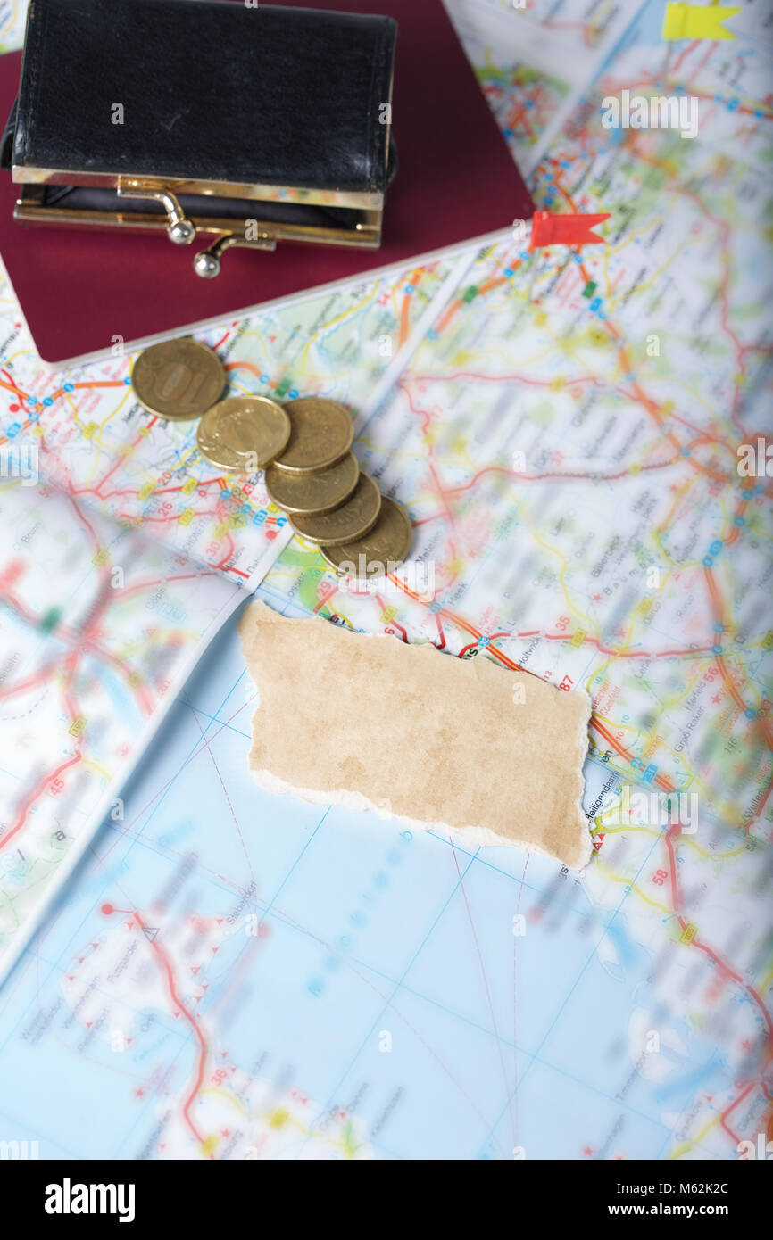 Wallet, coins, pass on a map. Closeup Stock Photo - Alamy