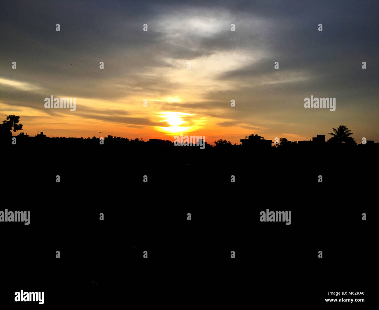 Sunset view with dark black and gray background of building and trees ...