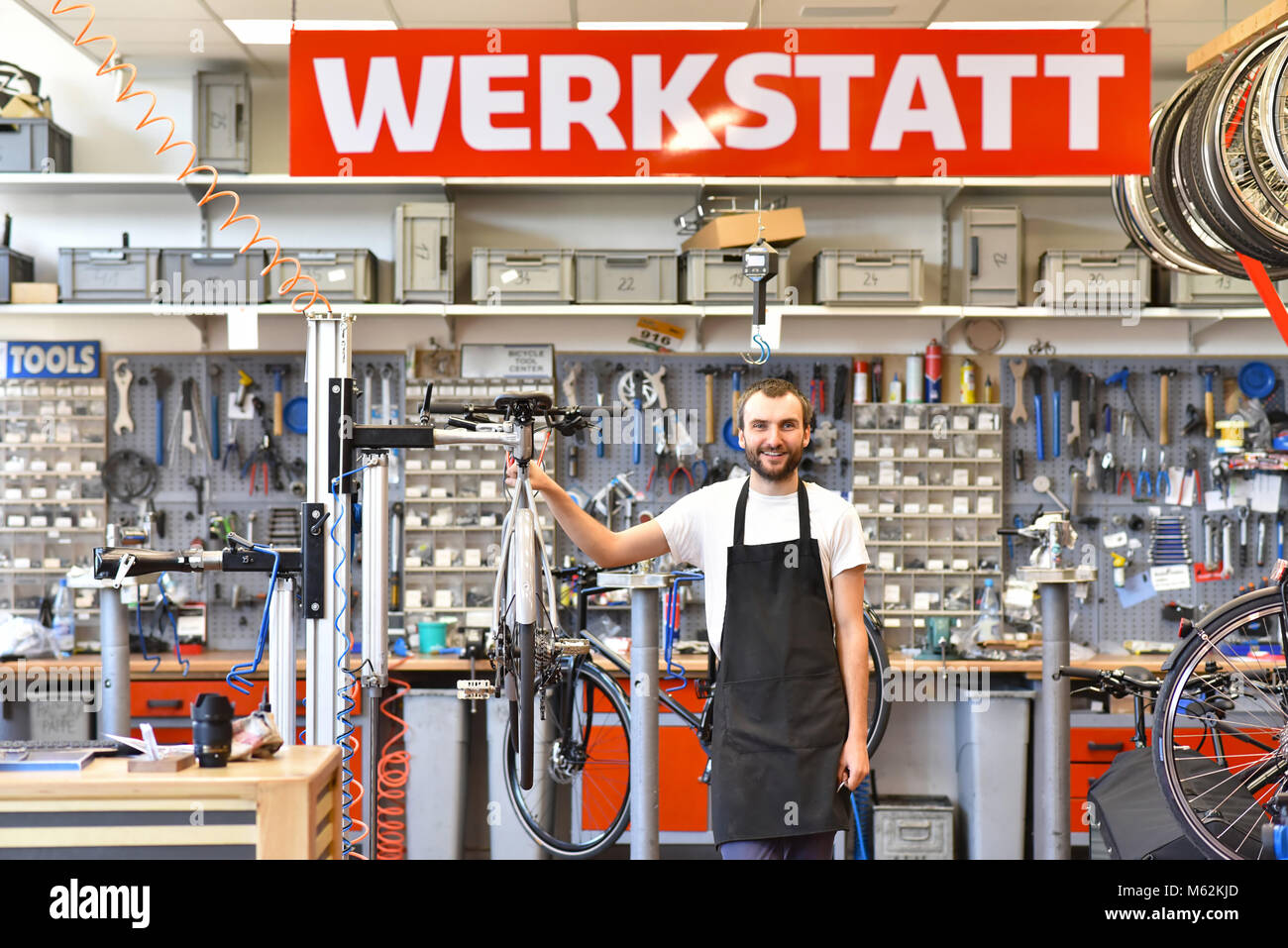 portrait of a young bicycle mechanic in the workshop Stock Photo - Alamy