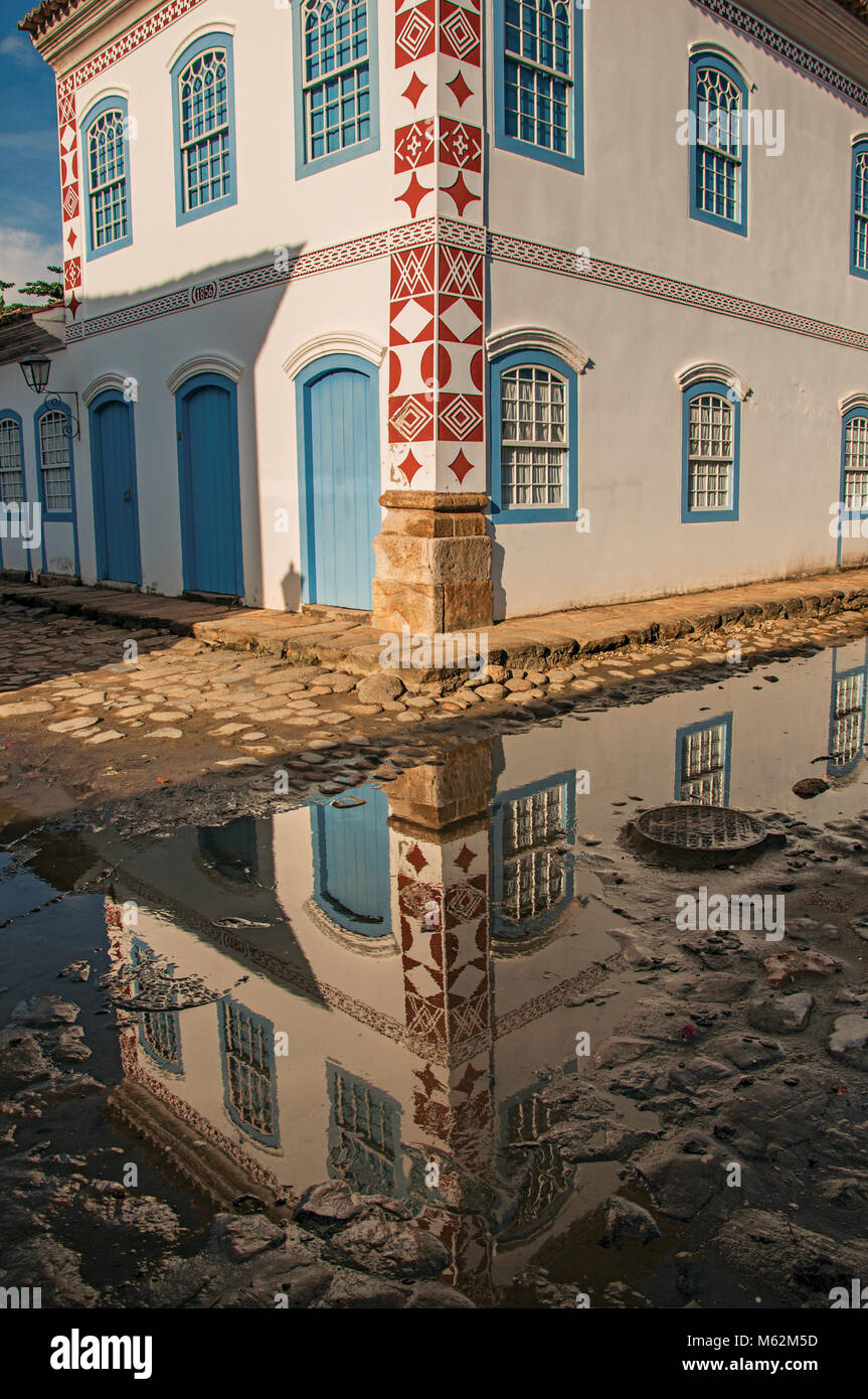 Overview of flooded cobblestone street with old houses at the sunset in ...