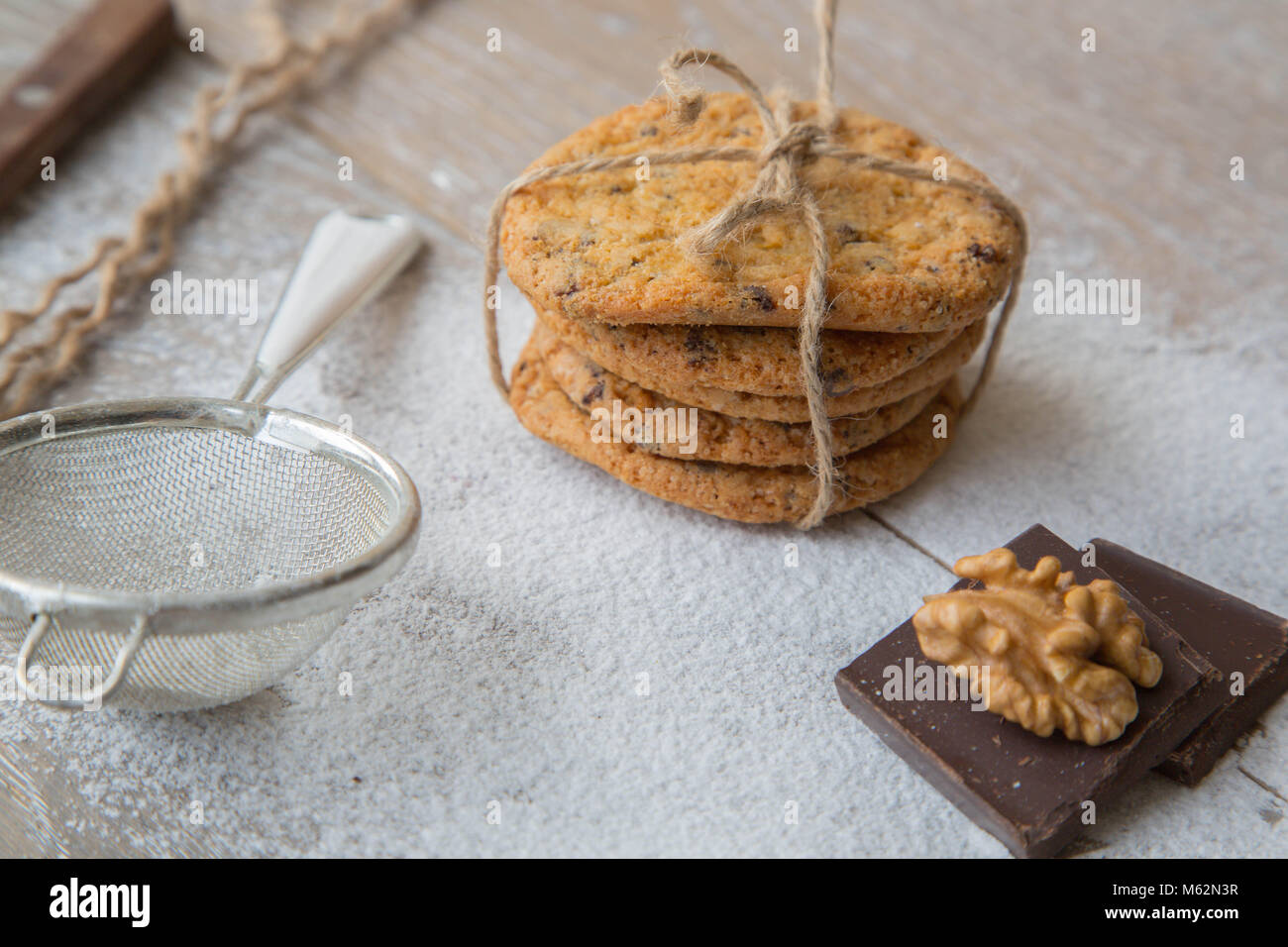 Five biscuits with wallnuts and chocolate chips bound with pack thread ...