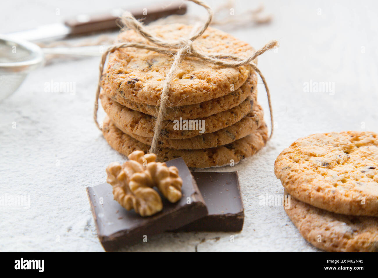 Five biscuits with wallnuts and chocolate chips bound with pack thread ...