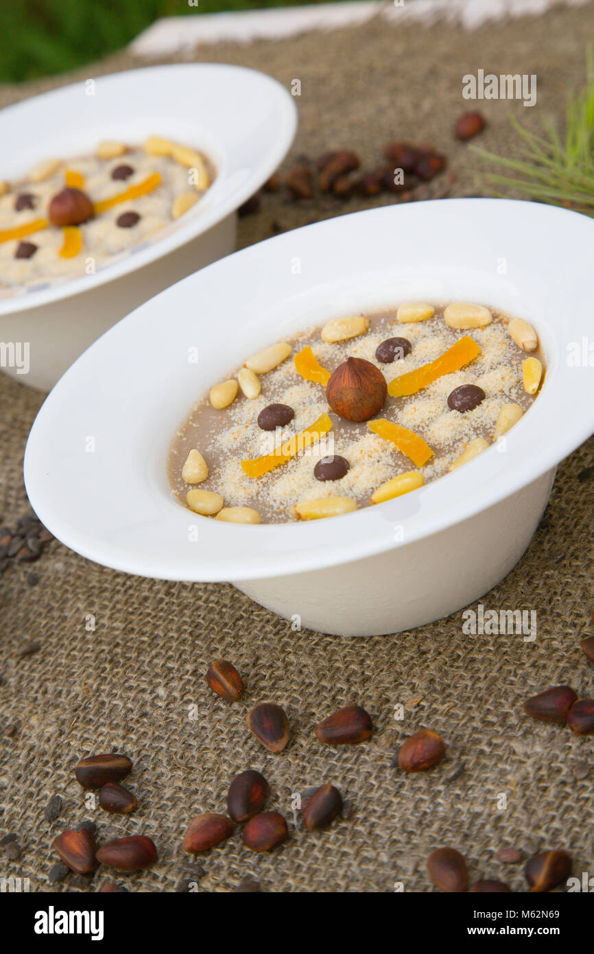 Assidat zgougou in white plates - traditional tunisian dessert prepared ...