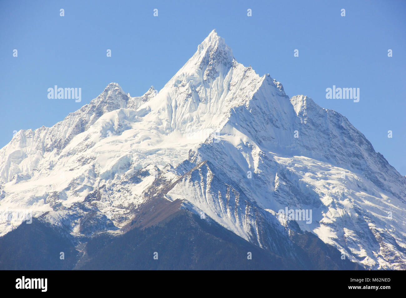 Kawagarbo snow mountain on a blue sky in Deqin, Yunnan province, China ...