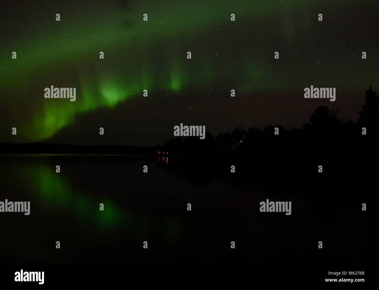 Aurora Borealis or Northern Lights reflected in the lake at Hotel ...