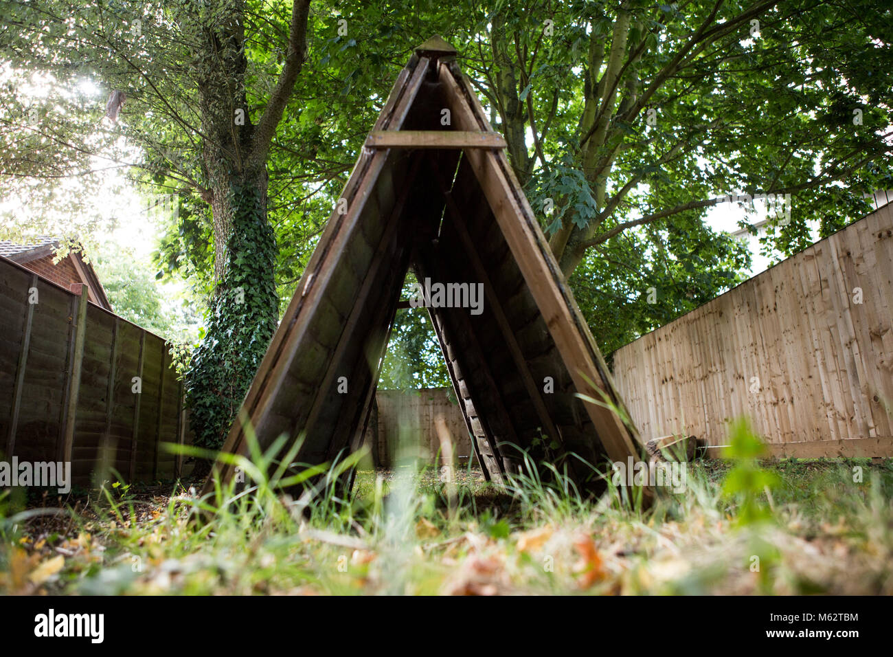 Childrens secret wooden den in domestic British garden Stock Photo - Alamy