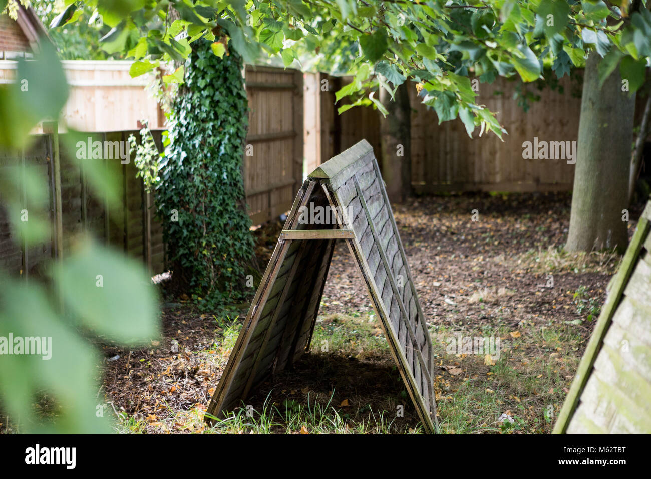 Childrens secret wooden den in domestic British garden Stock Photo - Alamy