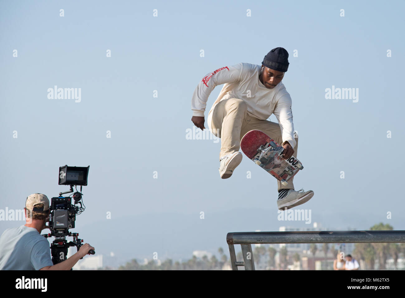 Filming a skateboarder performing tricks at Venice Beach Skatepark ...