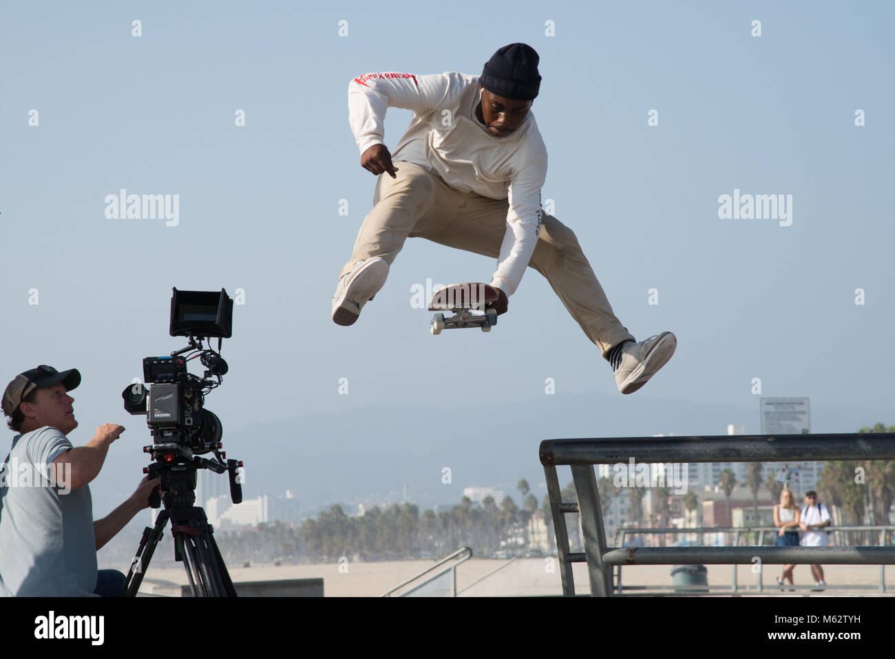 Filming a skateboarder performing tricks at Venice Beach Skatepark ...