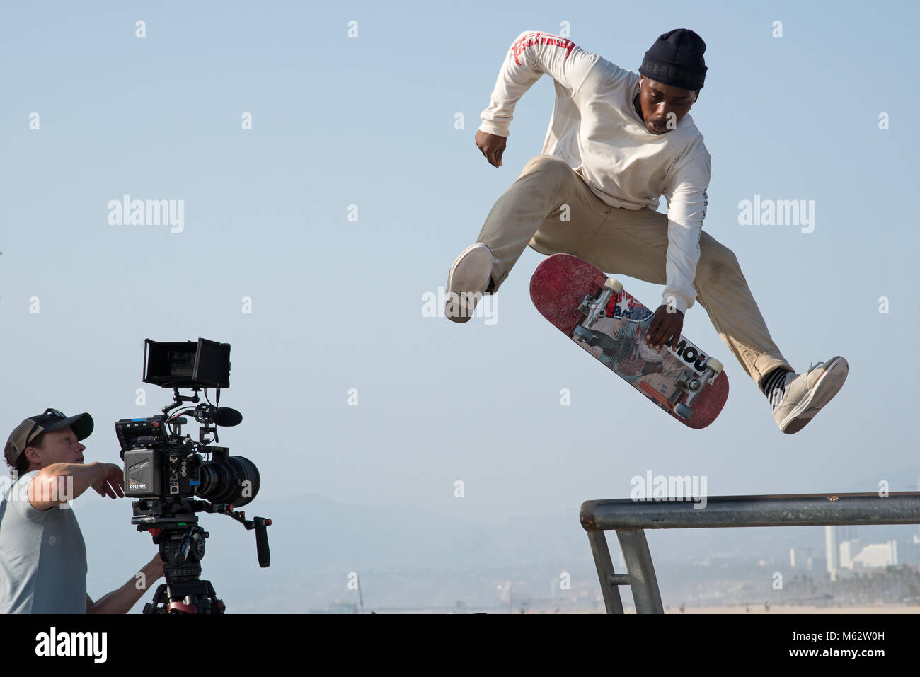 Filming a skateboarder performing tricks at Venice Beach Skatepark ...