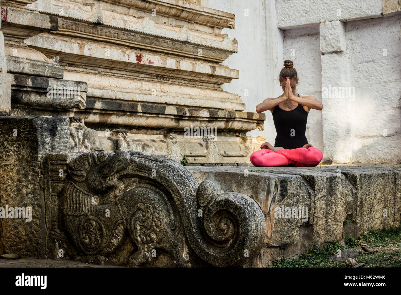 Yogi woman in padmasana pose with hands together on face in ...