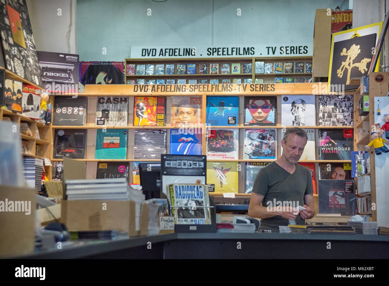 Man behind desk at record store Plato in Groningen, The Netherlands ...