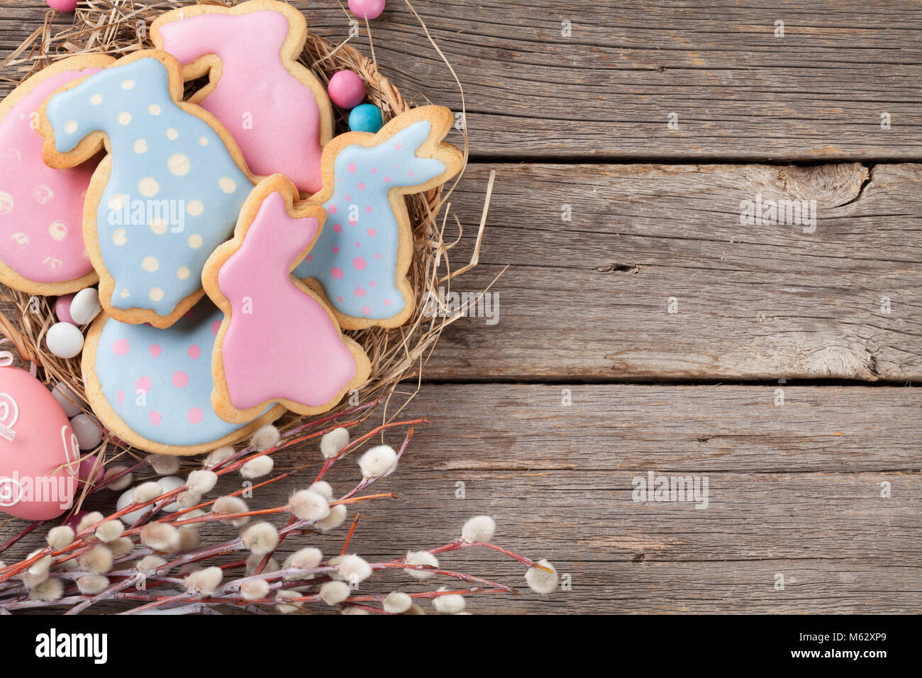Easter gingerbread cookies on wooden table. Rabbits and eggs. Greeting ...