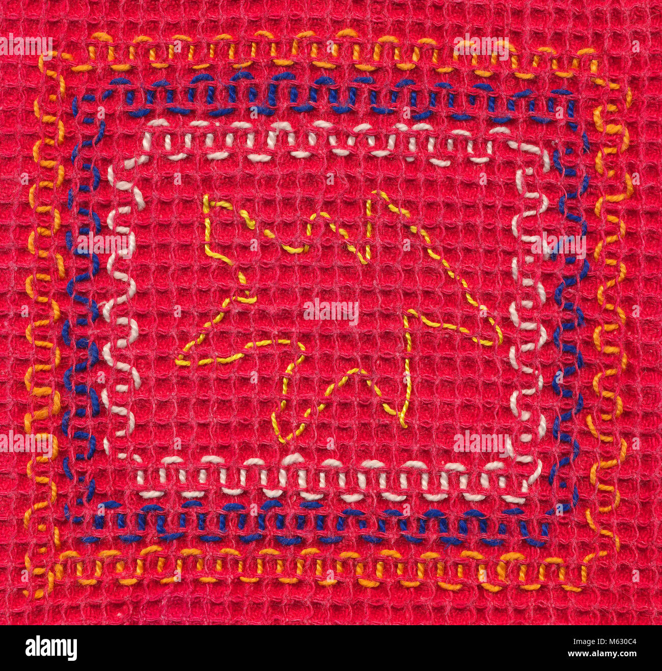 Child's embroidery, red background, simple stitches Stock Photo - Alamy