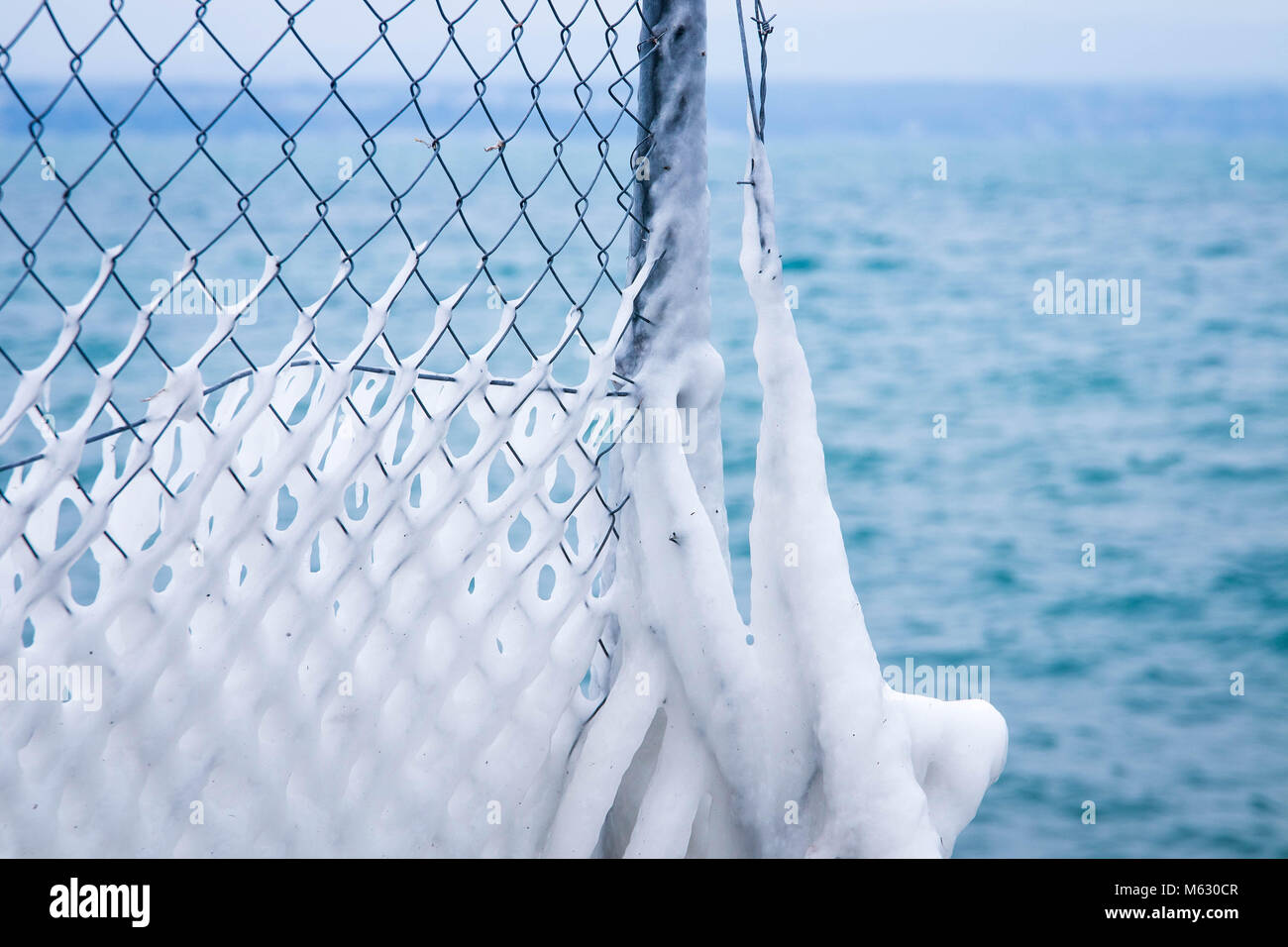 Frozen fence Ice lake cover by ice Stock Photo - Alamy