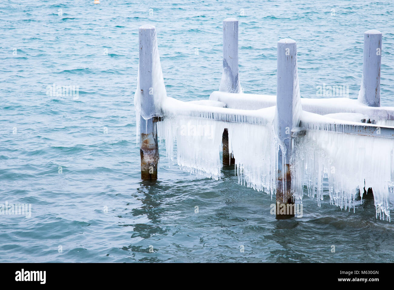 Frozen dock covered by ice storm winter lake Stock Photo - Alamy
