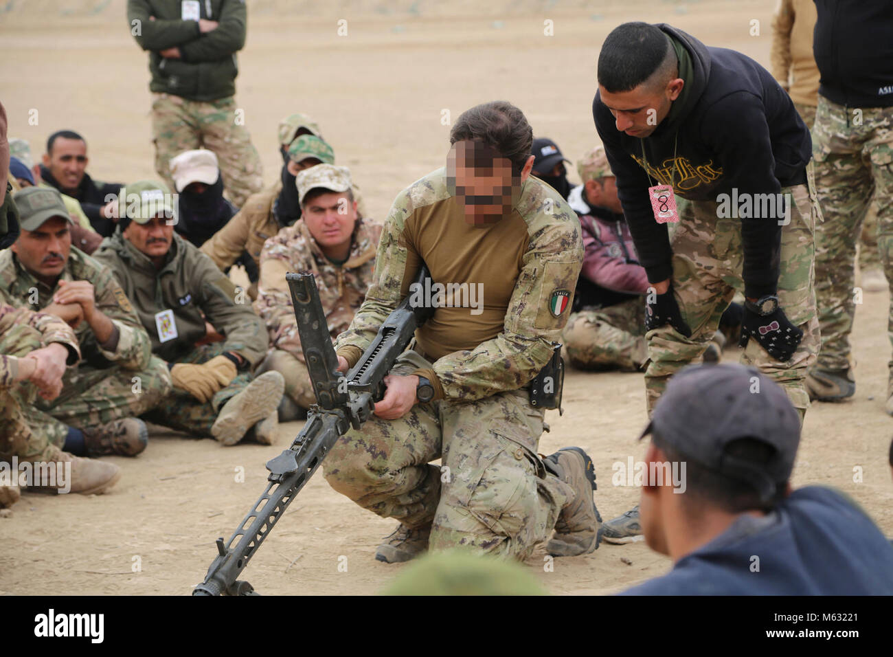 An Italian coalition member shows an Iraqi soldier the proper barrel ...