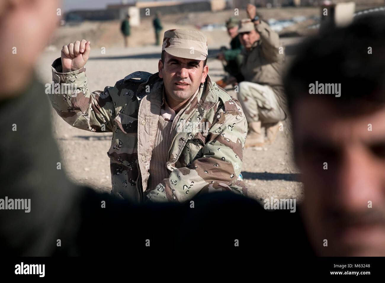 A security force member is using hand signals while learning basic ...