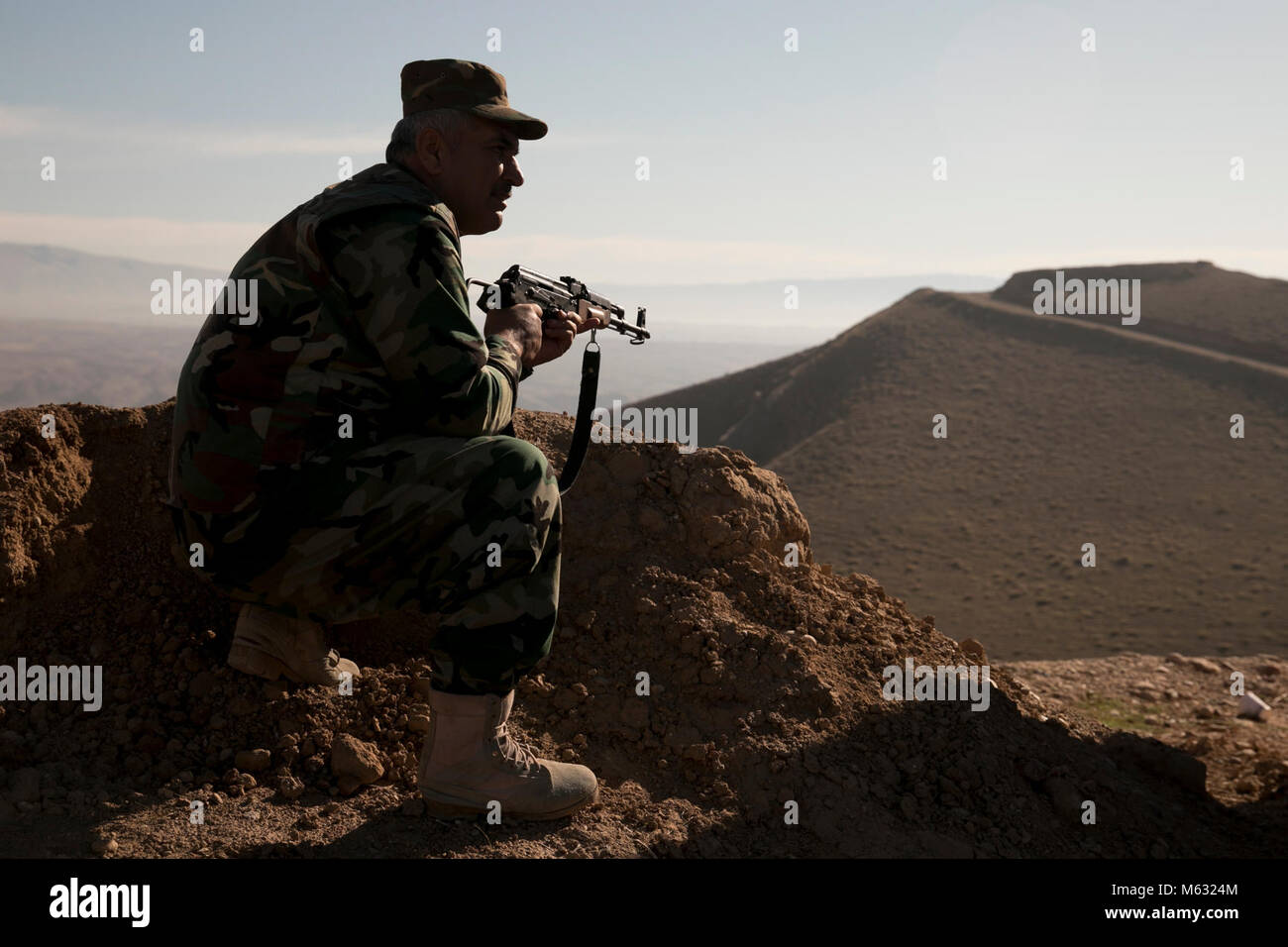 A security force member is scanning his sector of fire while learning ...
