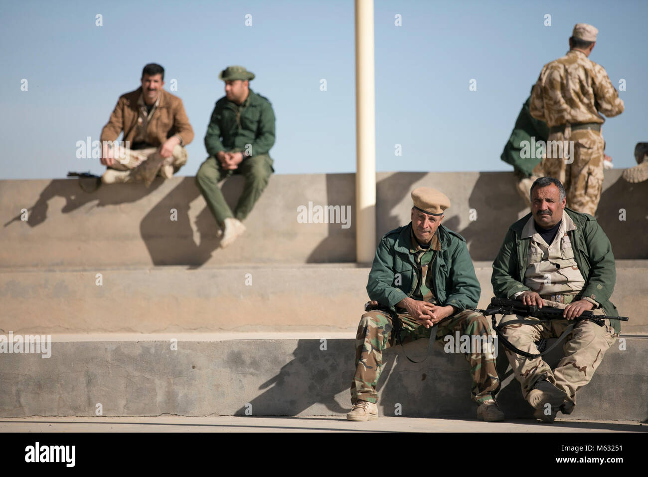 Security force members observe a training exercise while learning basic ...