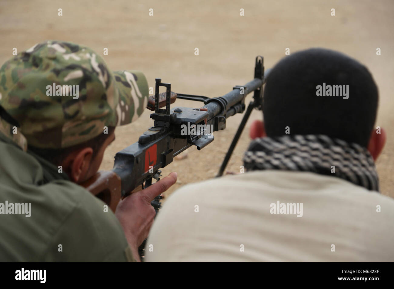 Iraqi soldiers fire the PKC machine gun during a live fire exercise of ...