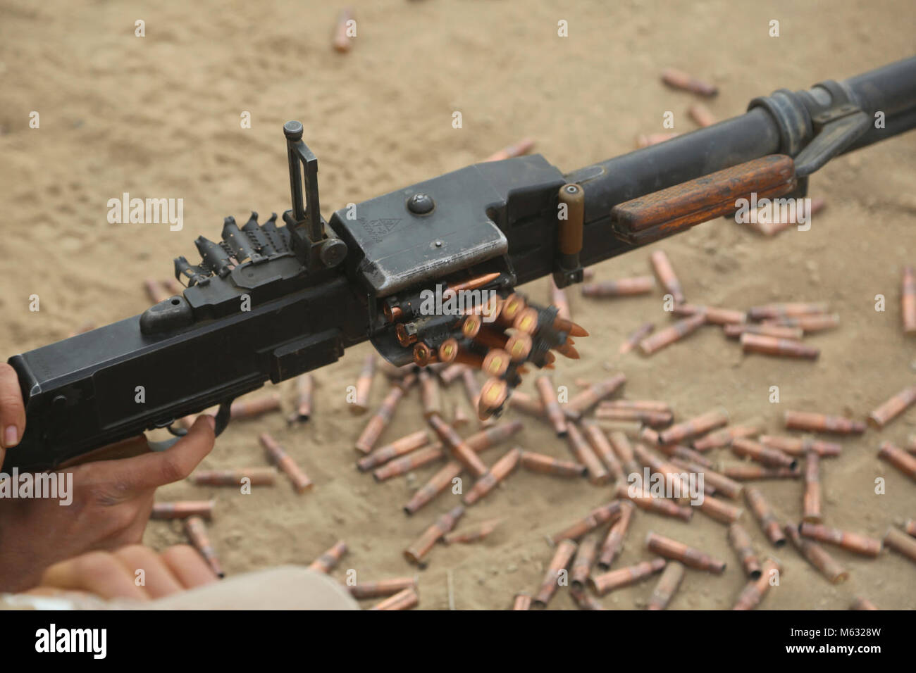 An Iraqi soldier fires the PKC machine gun during the live fire ...