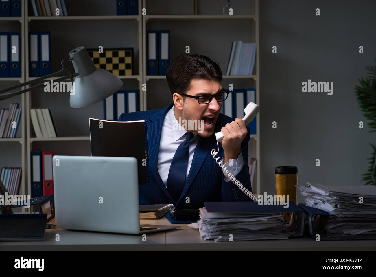 Employee working late to finish important deliverable task Stock Photo ...