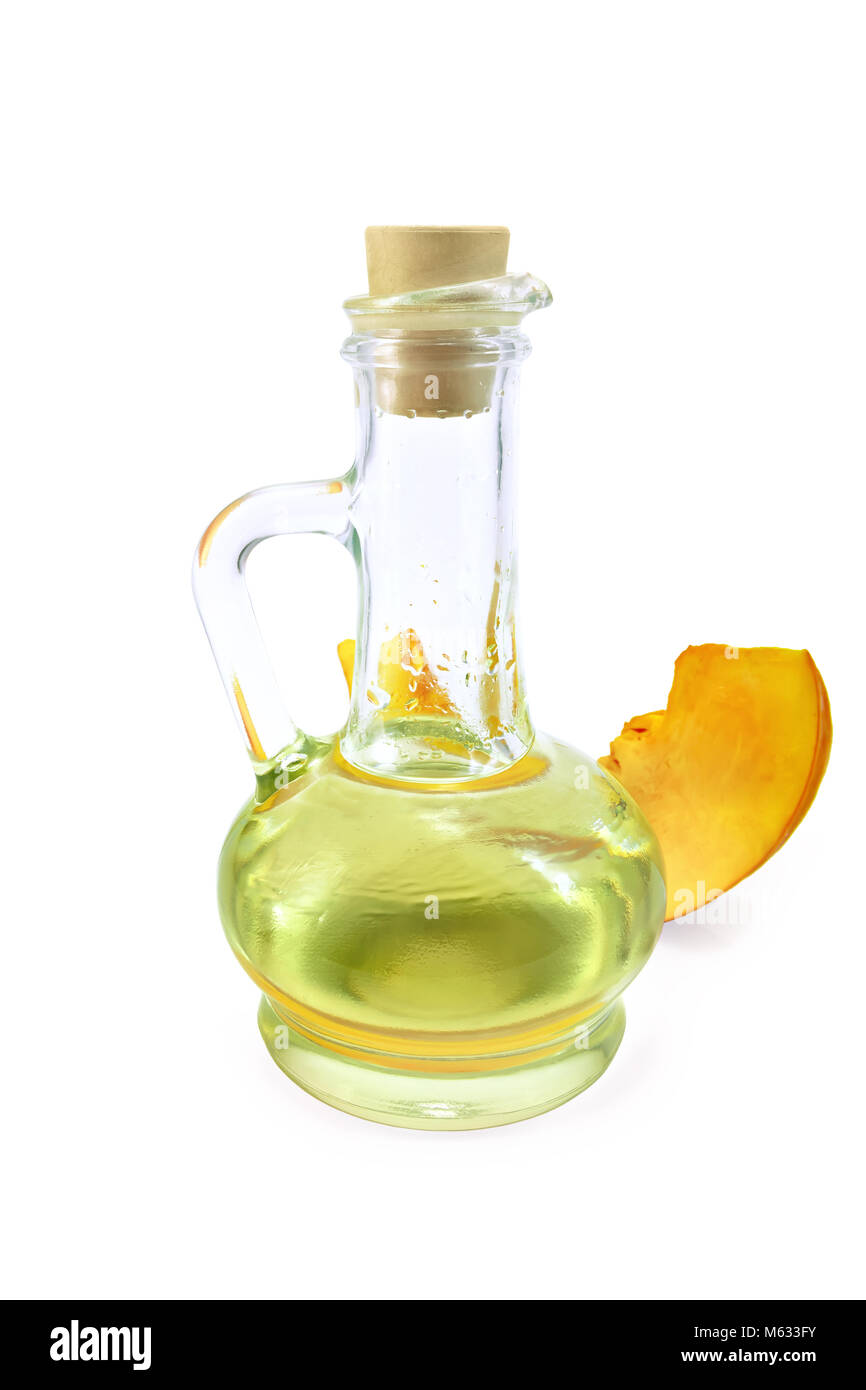 Pumpkin oil in a glass decanter with a vegetable slice isolated on a ...