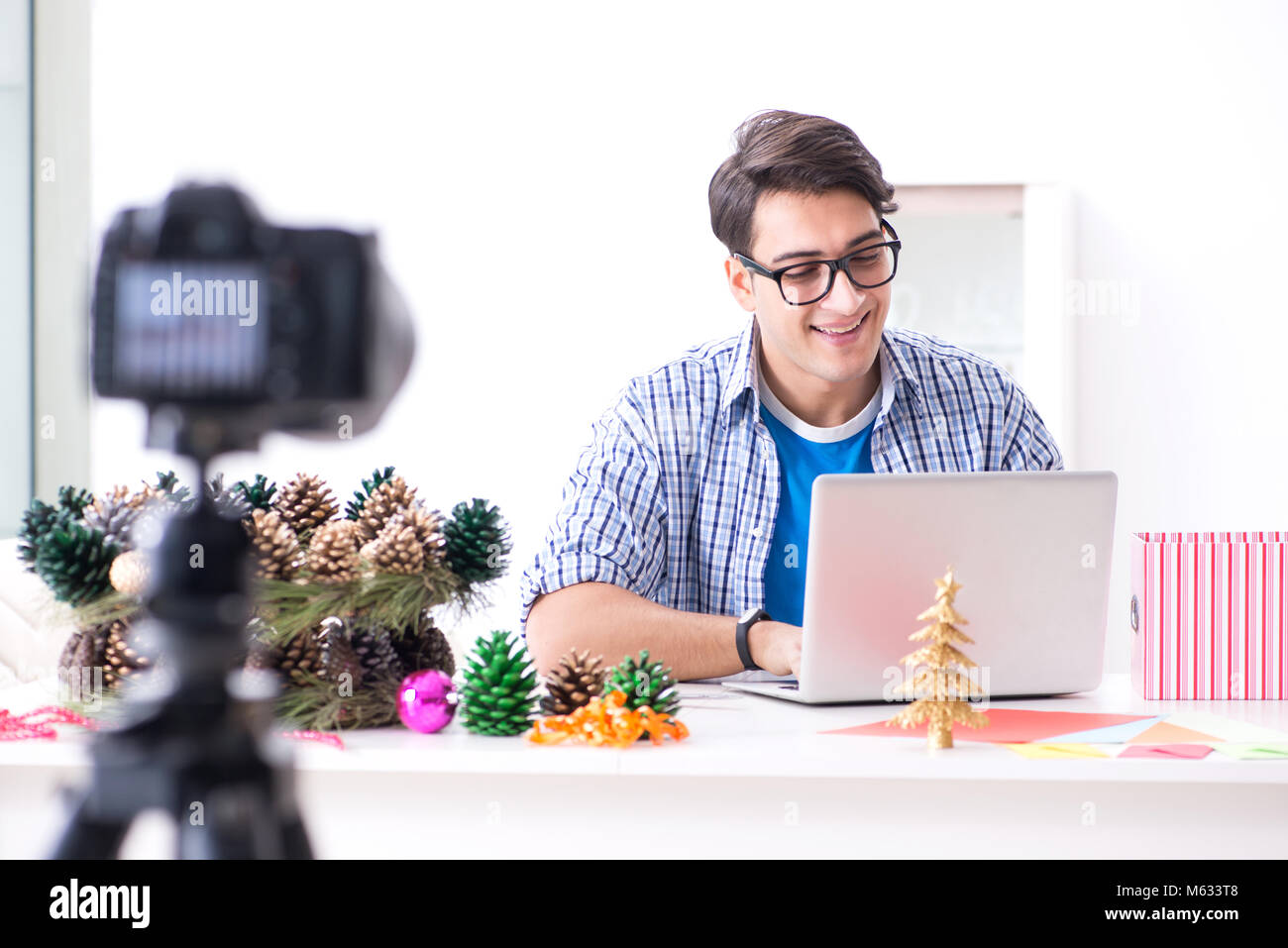 Young vlogger recording video doing christmas decoration Stock Photo ...