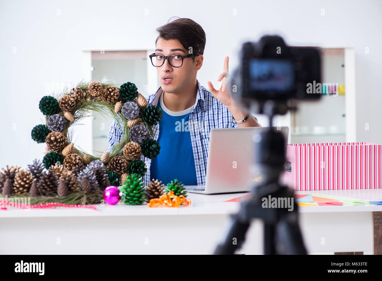 Young vlogger recording video doing christmas decoration Stock Photo ...