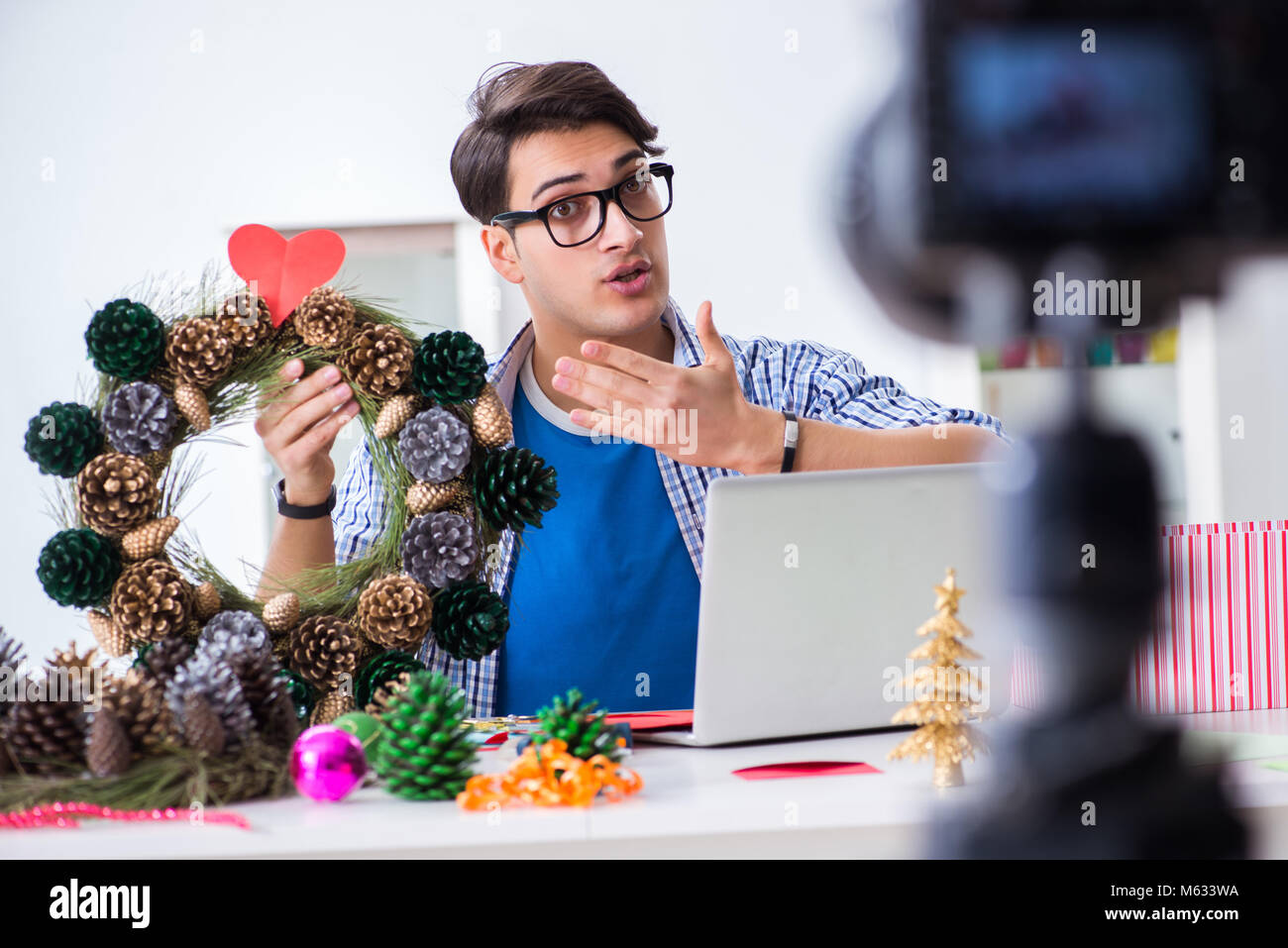 Young vlogger recording video doing christmas decoration Stock Photo ...