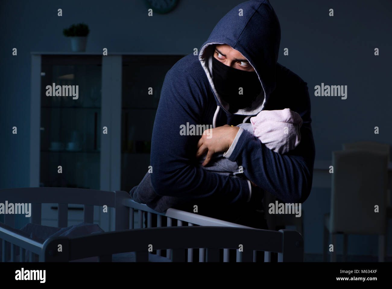 Criminal stealing baby in human child traficking concept Stock Photo ...