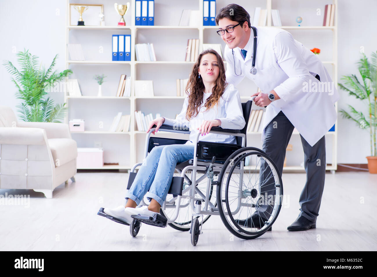 Disabled patient on wheelchair visiting doctor for regular check up ...