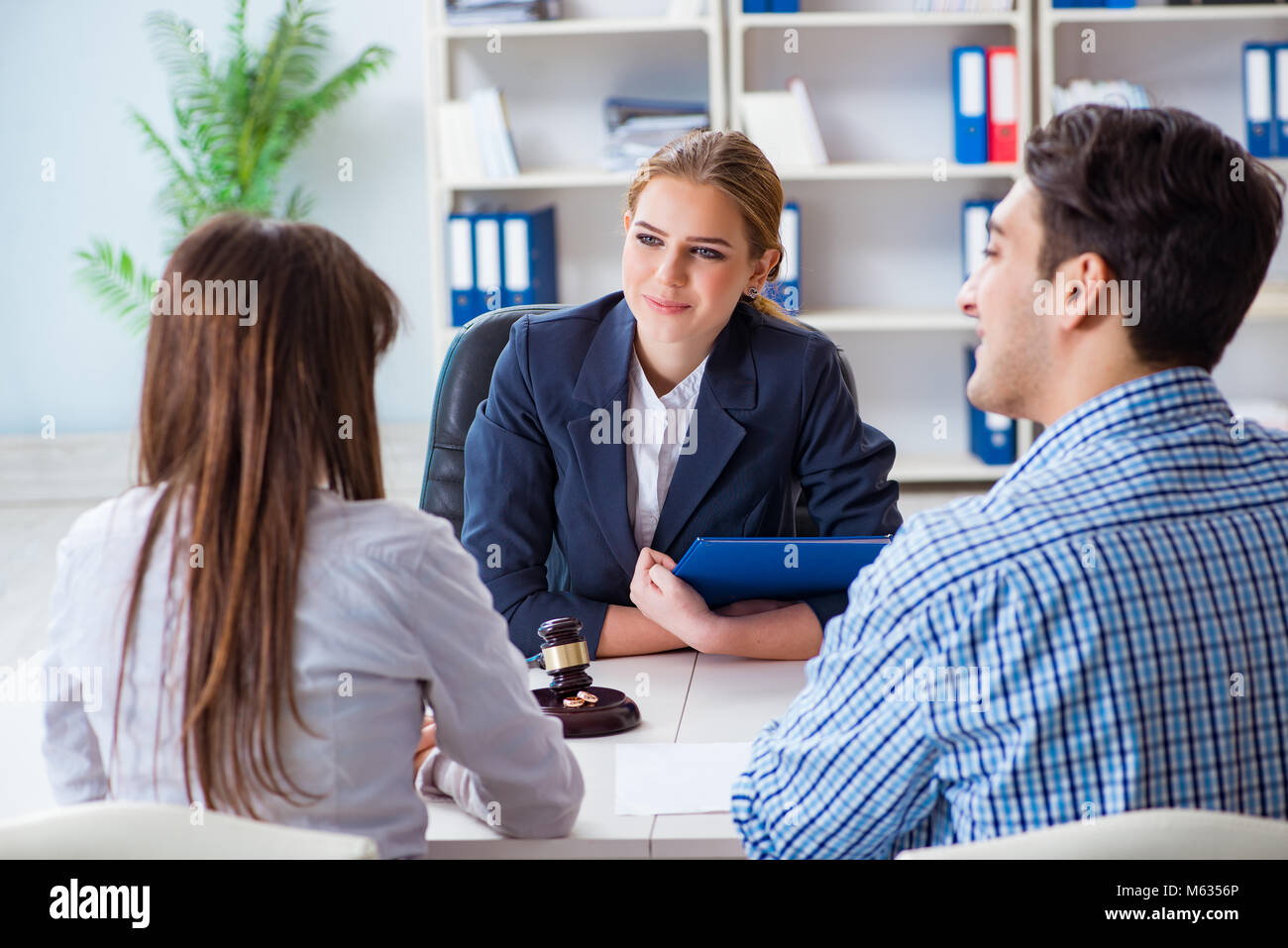 Young family signing marriage documents at laywers office Stock Photo ...