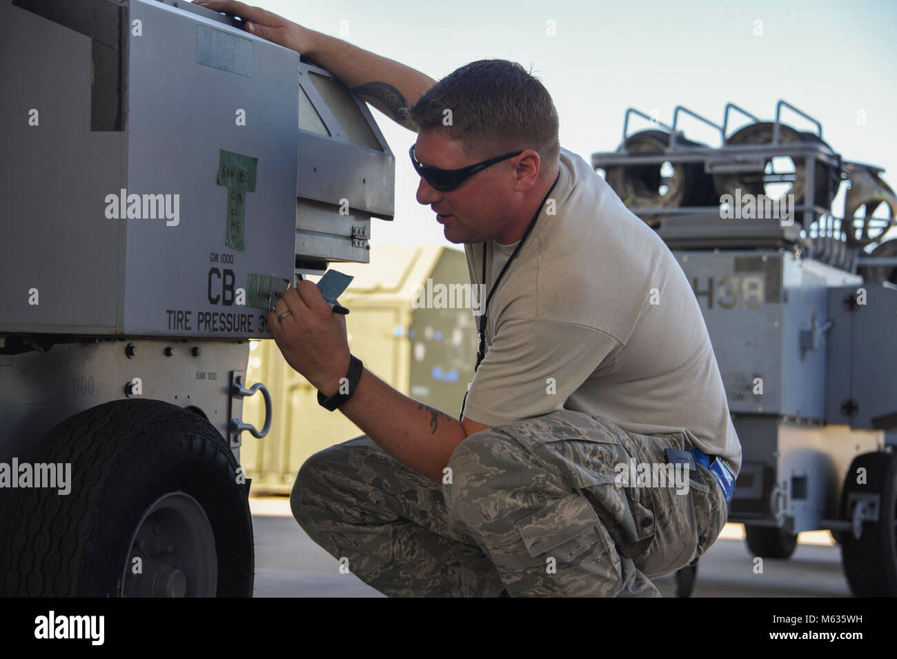A U.S. Airman records the weight of cargo during the Bushwhacker 18-02 ...