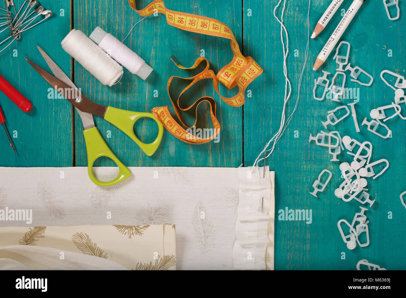 Process of attaching pleat tape to curtains. Top view Stock Photo - Alamy