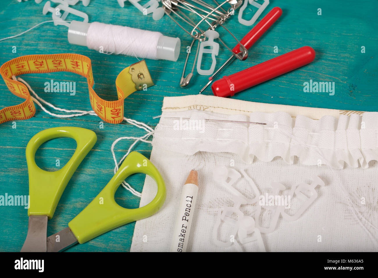 Process of attaching pleat tape to curtains. Top view Stock Photo - Alamy