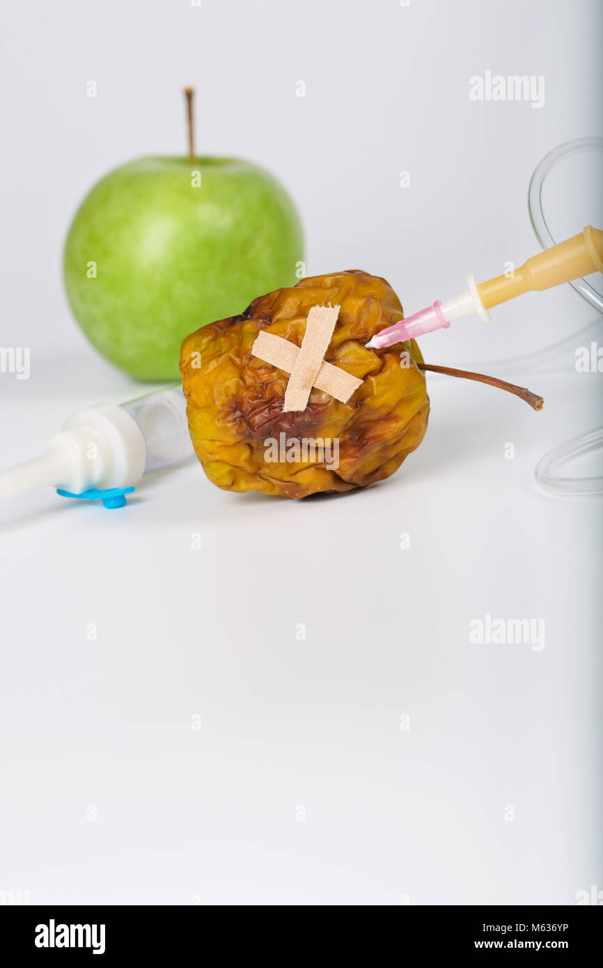 Shrivelled apple with blood transfusion set. Closeup Stock Photo - Alamy