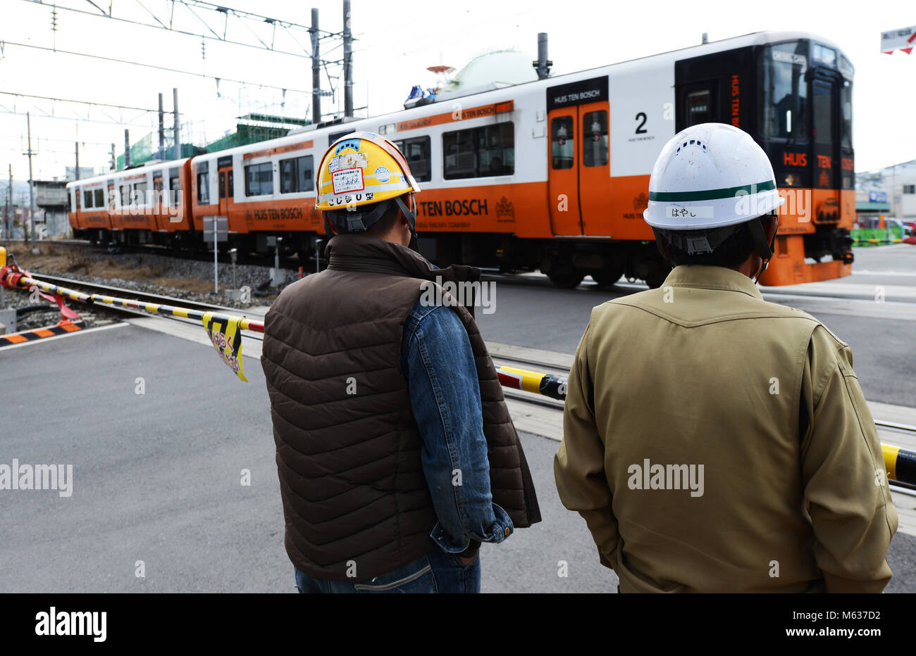 Japanese construction workers waiting for the train to pass Stock Photo ...